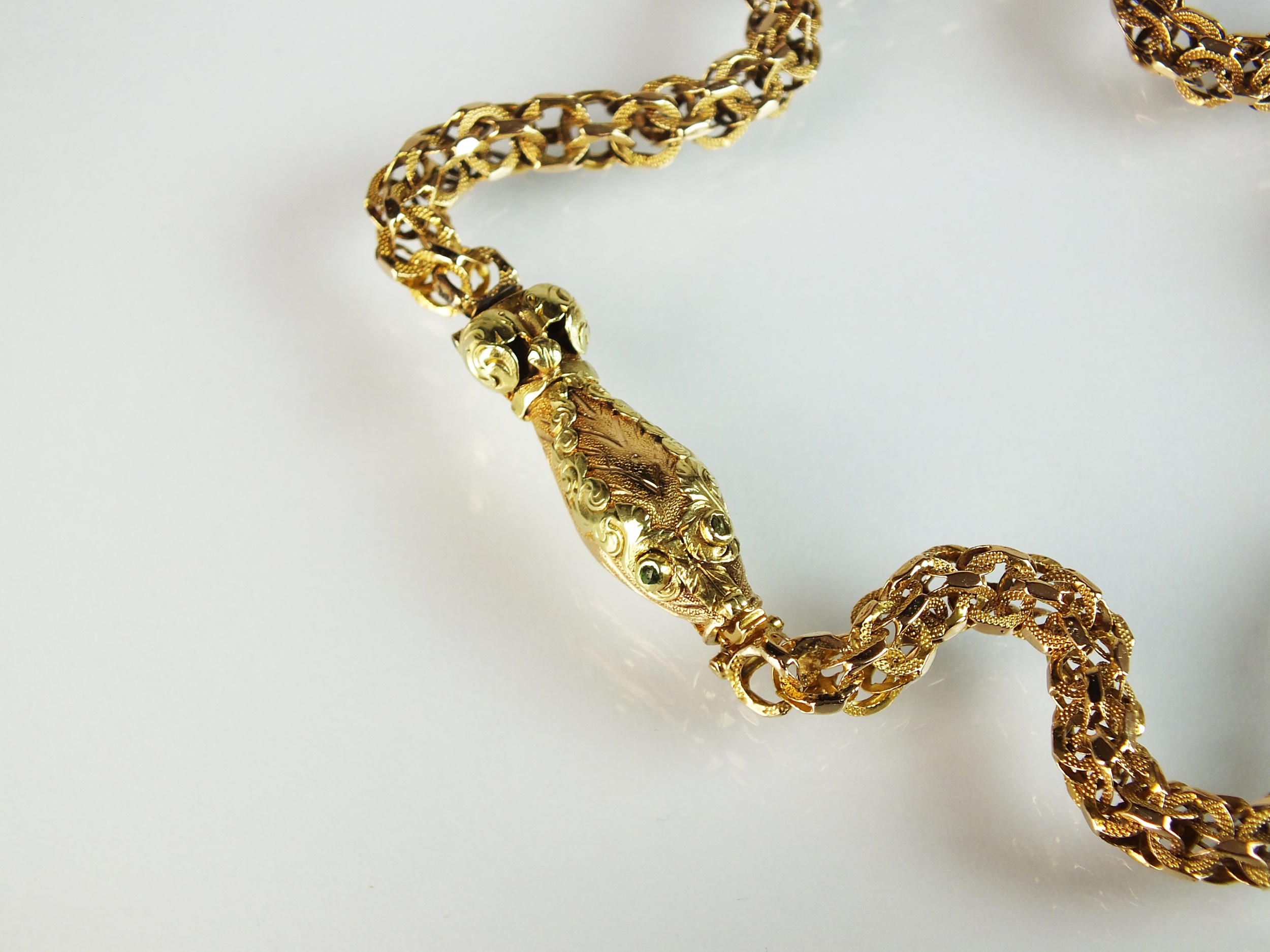 Lot 127 - An early 19th century chain with snakes head