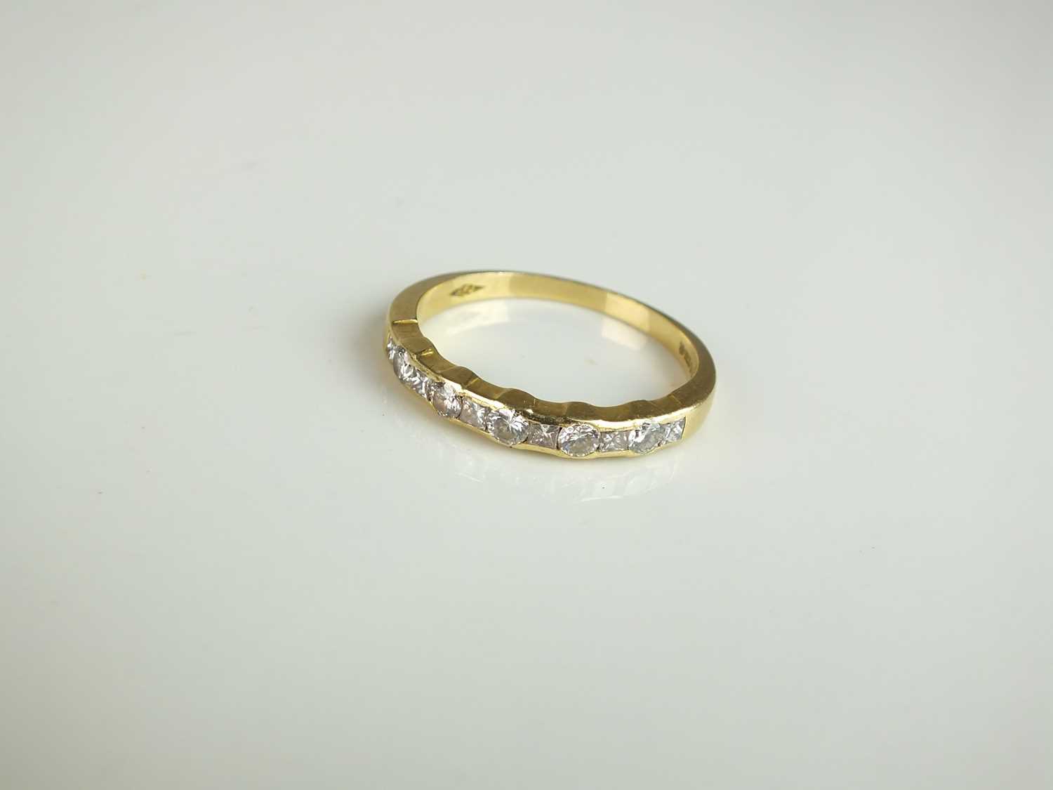 Lot 184 - An 18ct gold eleven stone diamond set half