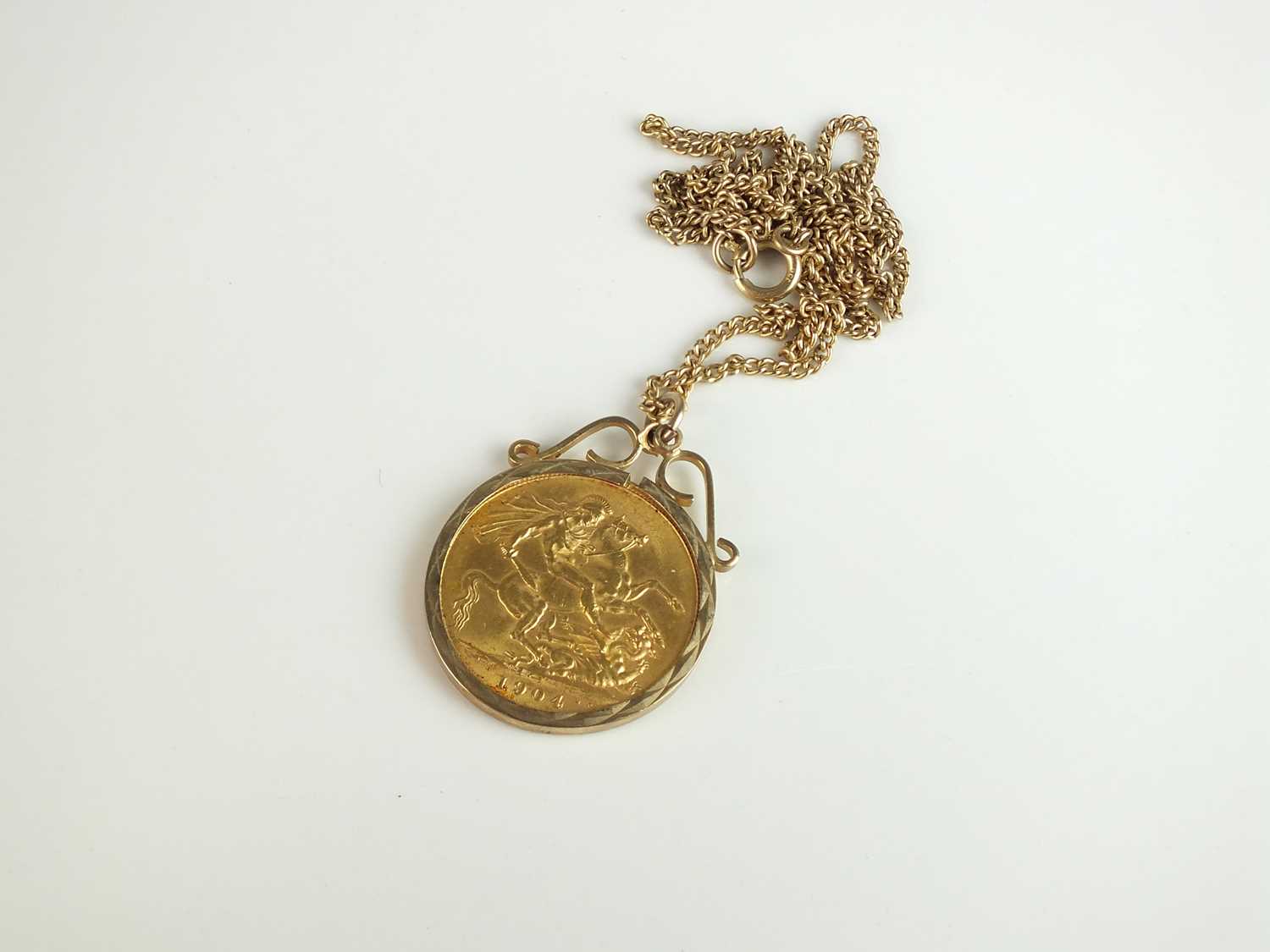 Lot 310 - An Edwardian sovereign pendant on chain