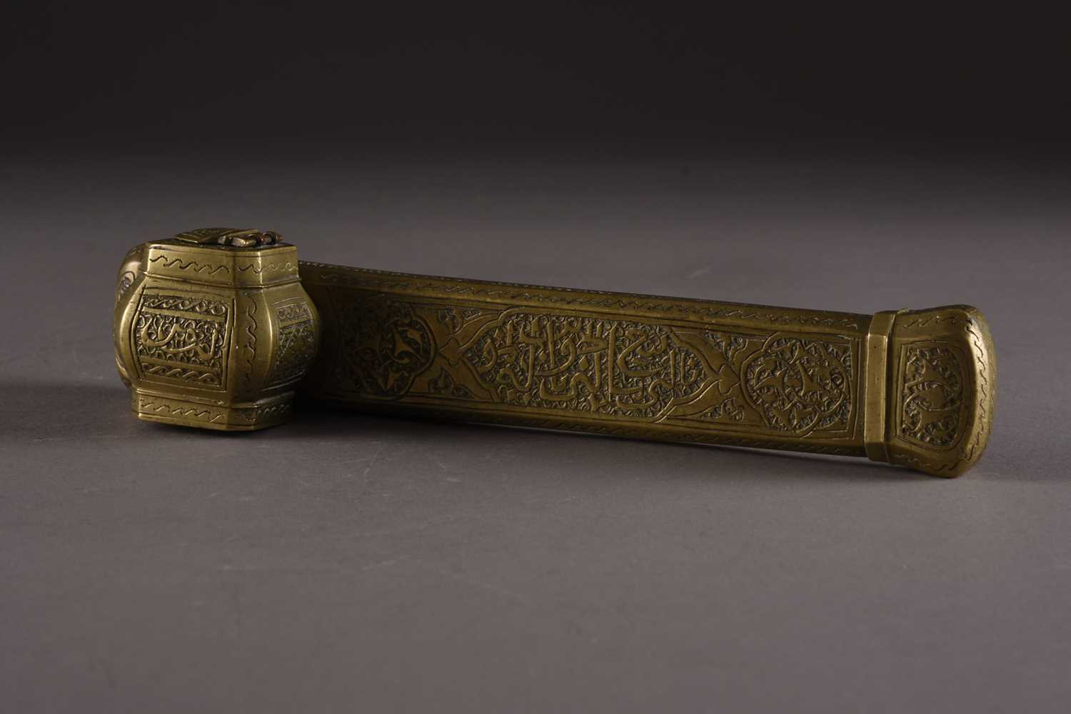 Lot 60 - A Persian brass inkwell and pen case or